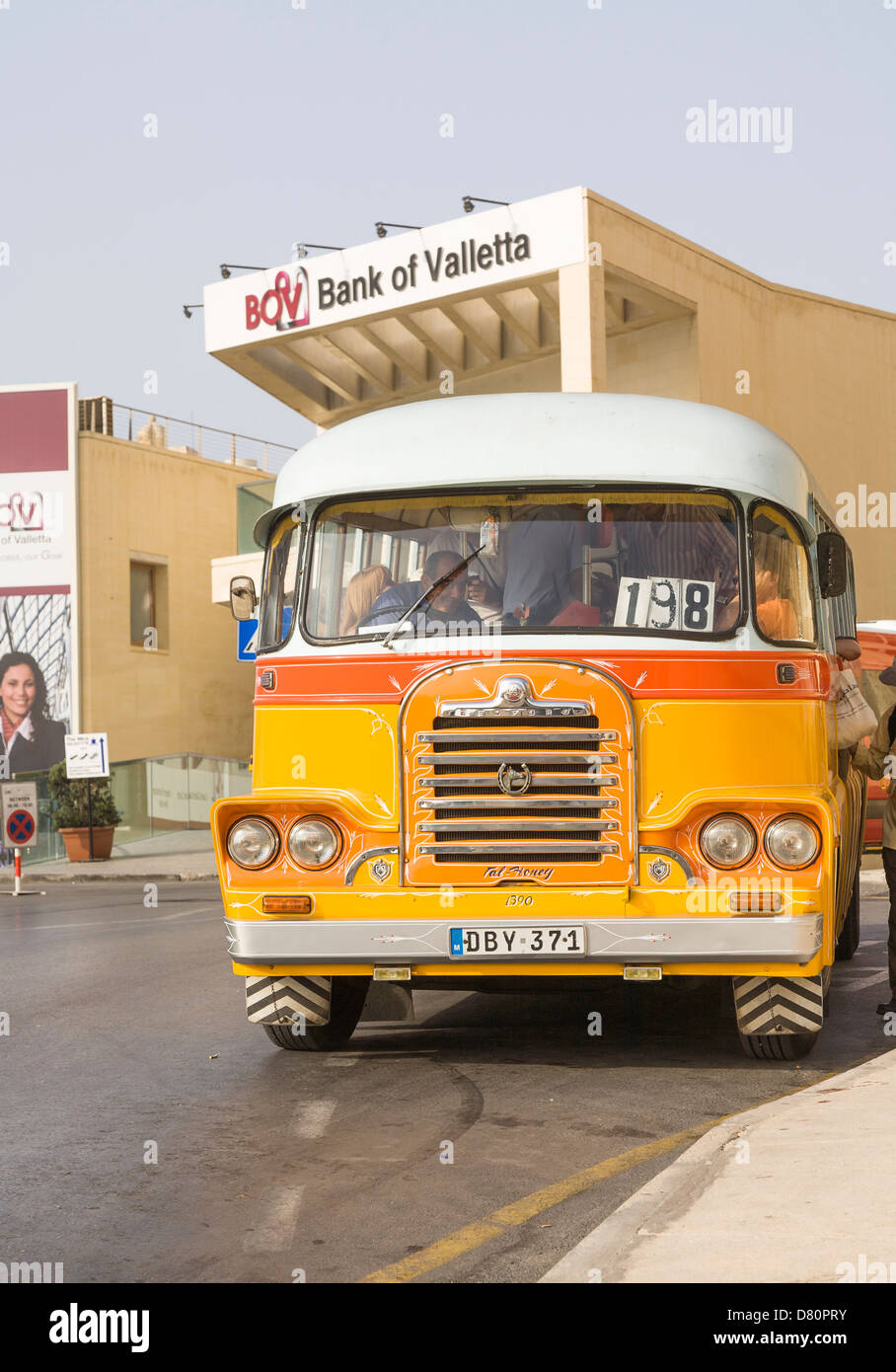 Yellow bus at Valletta Malta in front of the Bank of Valletta Stock ...