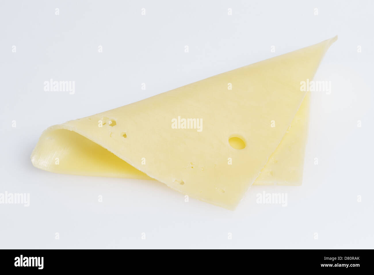 square slices of edam cheese, on gray background Stock Photo - Alamy