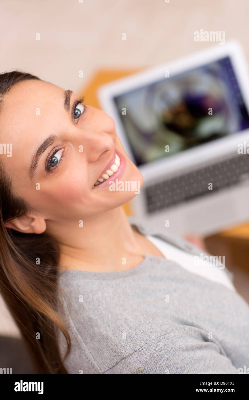 Female looking at pictures on her computer Stock Photo - Alamy