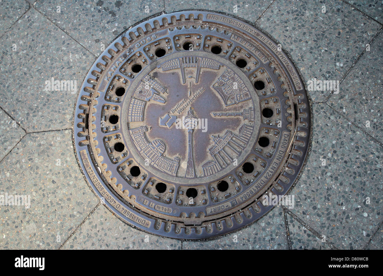 Manhole cover of the Berlin, inscribed with signs of the monuments of ...