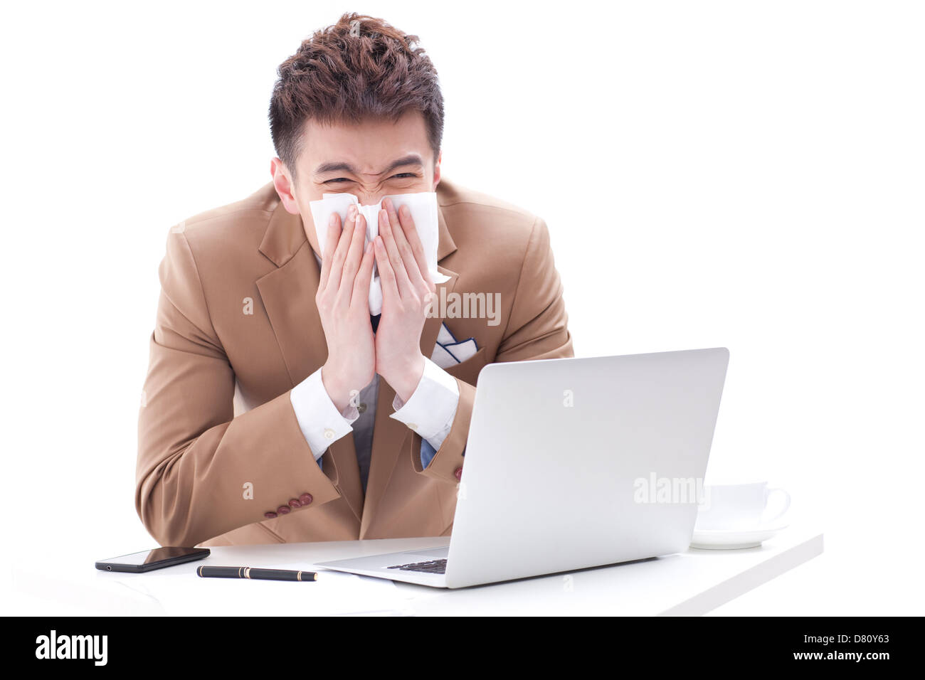 Stylish young businessman blowing his nose in office Stock Photo - Alamy