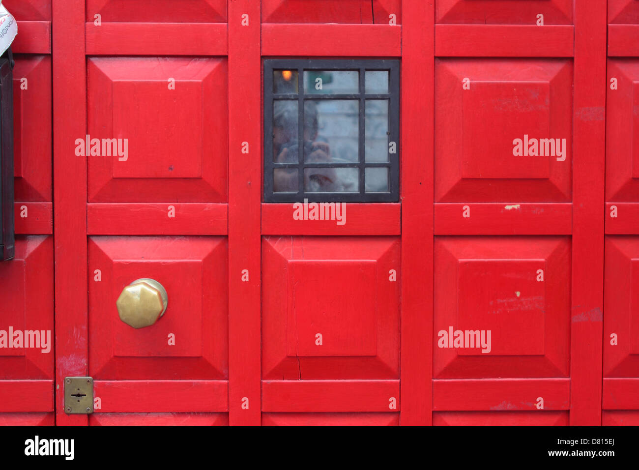 Red door of a club with window Stock Photo - Alamy