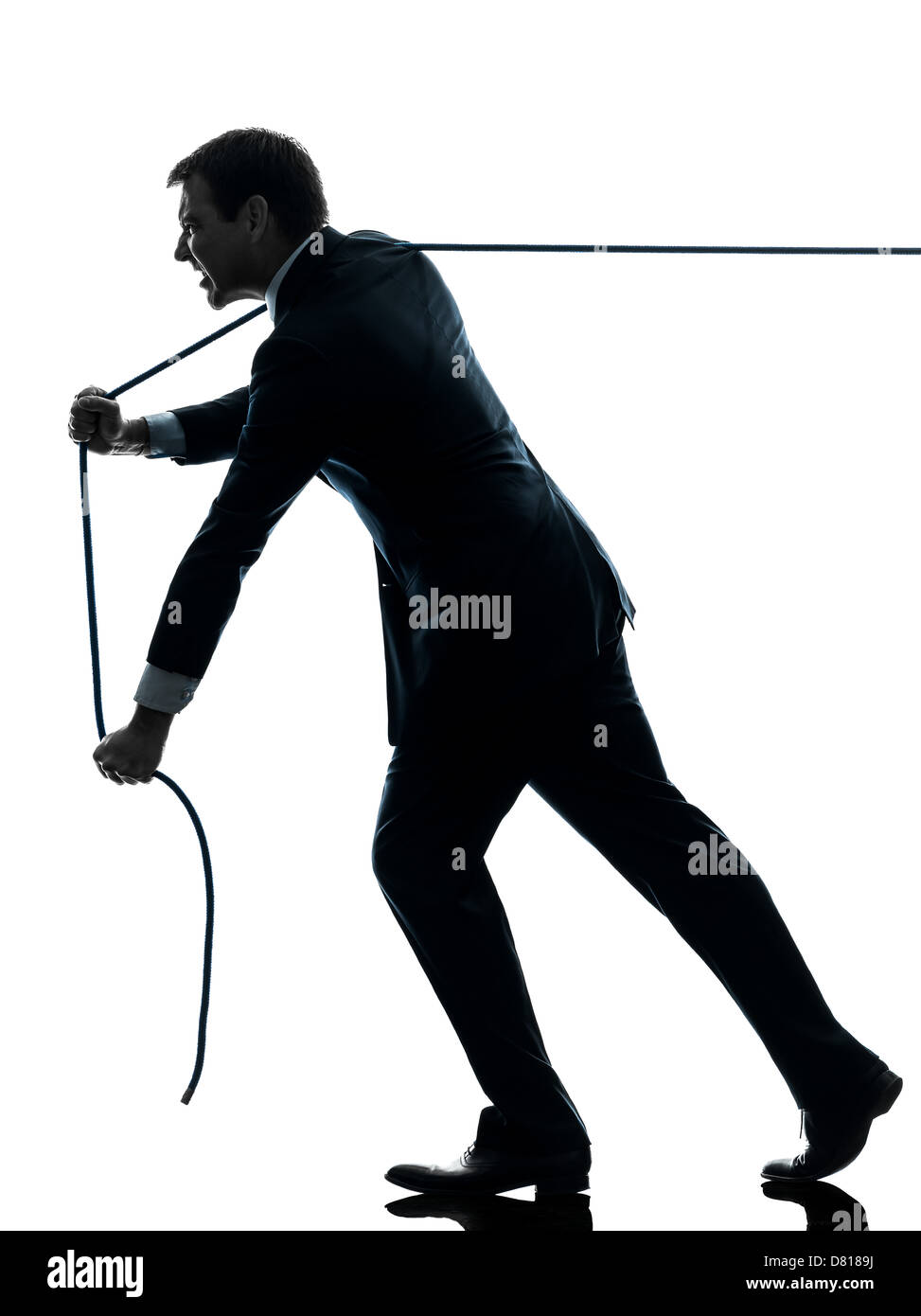 one business man pulling a rope in silhouette studio isolated on white ...