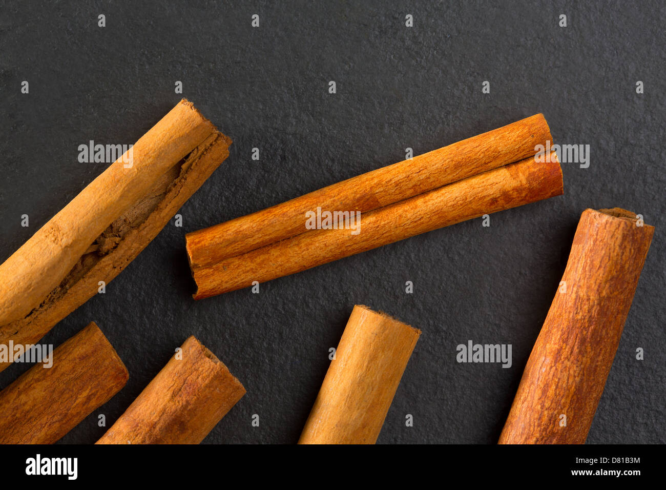 Cinnamon spice macro closeup detail on black slate stone background ...