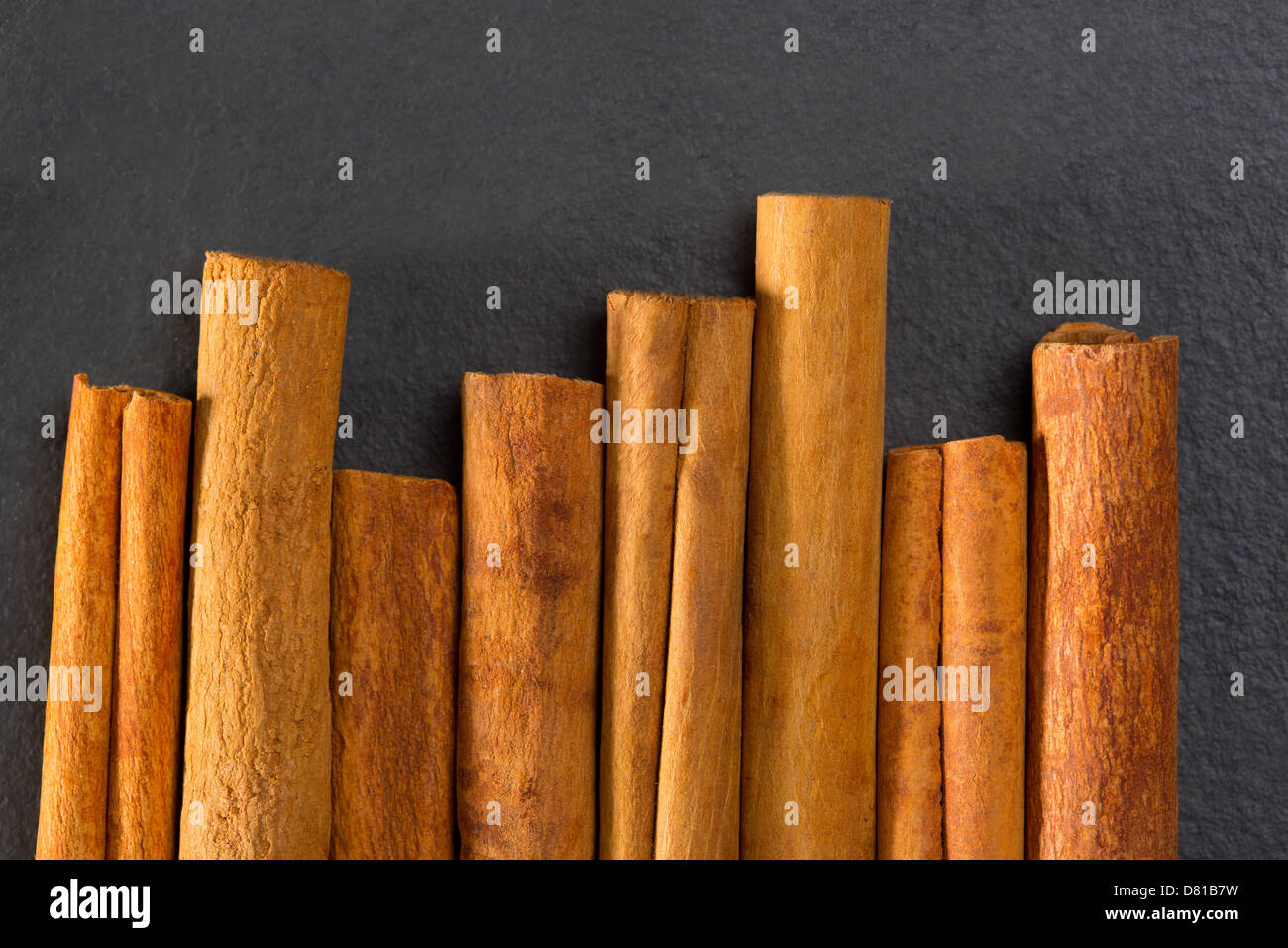 Cinnamon spice macro closeup detail on black slate stone background ...