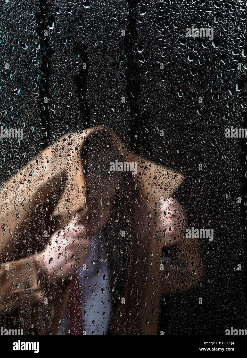 Businessman covered from rain, viewed through window Stock Photo - Alamy