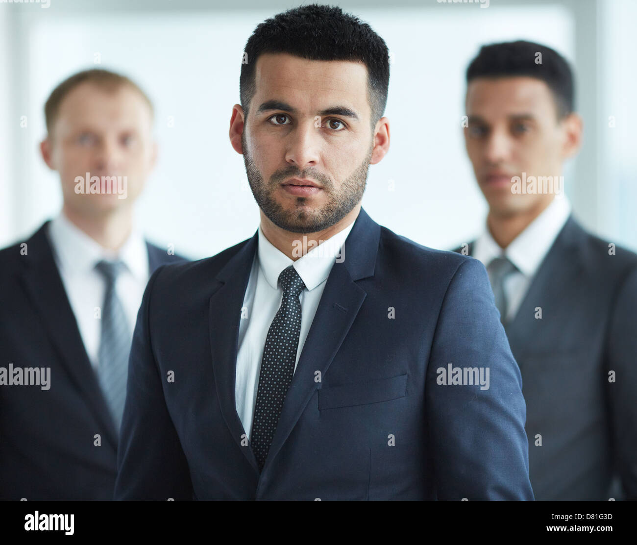 Portrait of confident businessmen looking at camera with serious leader ...