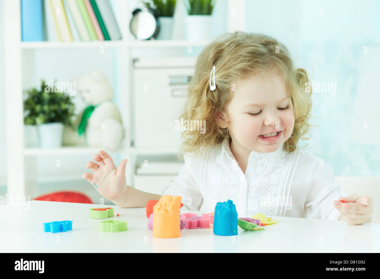 Little girl modeling with clay at kindergarten Stock Photo - Alamy