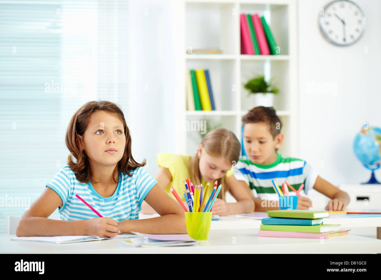 Portrait of lovely girl concentrating on drawing at workplace with ...