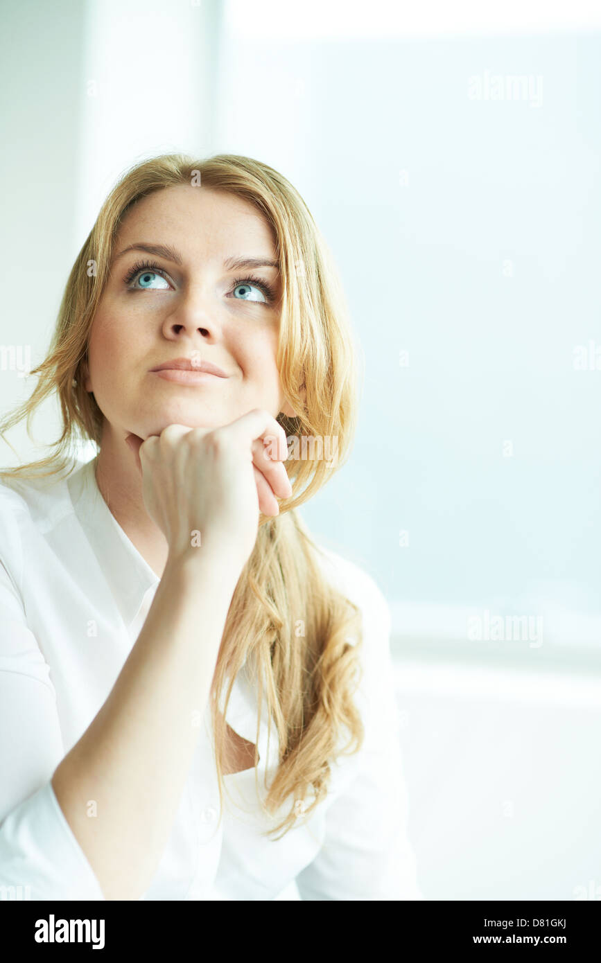 Portrait of lovely girl touching her chin and looking upwards Stock ...