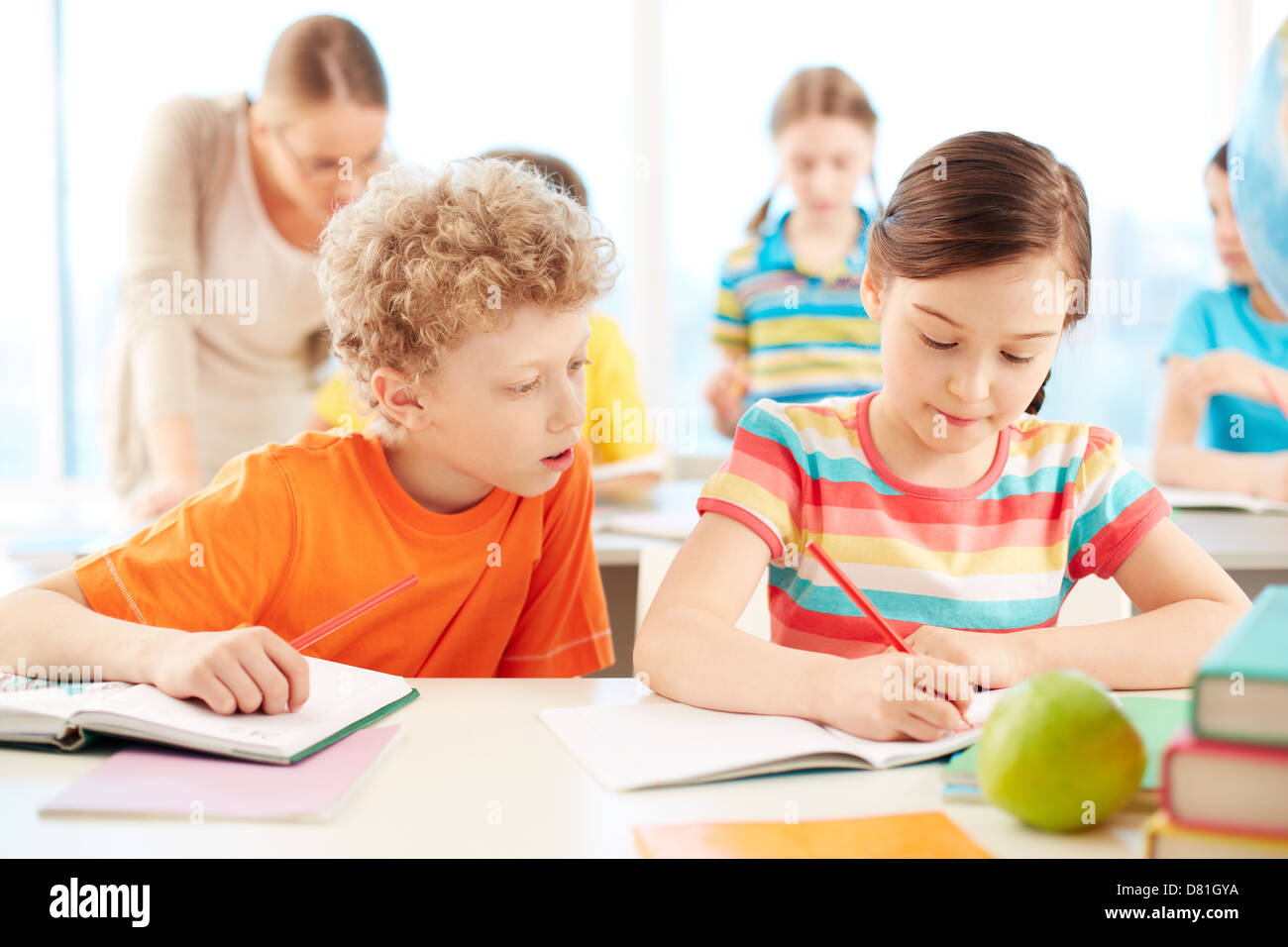Portrait of two diligent pupils drawing at lesson Stock Photo - Alamy