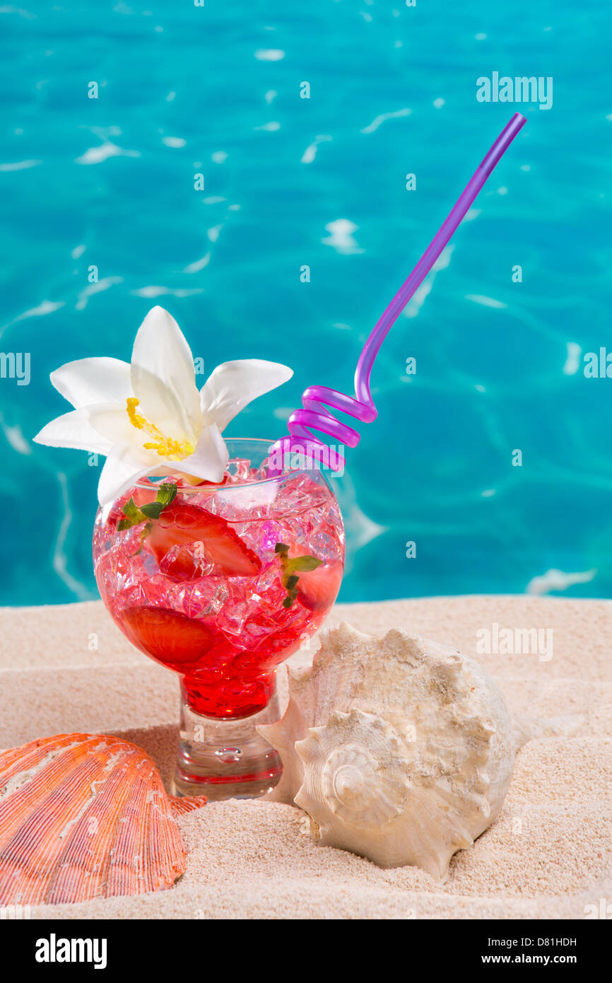 Strawberry cocktail on beach sand with seashell and turquoise beach ...