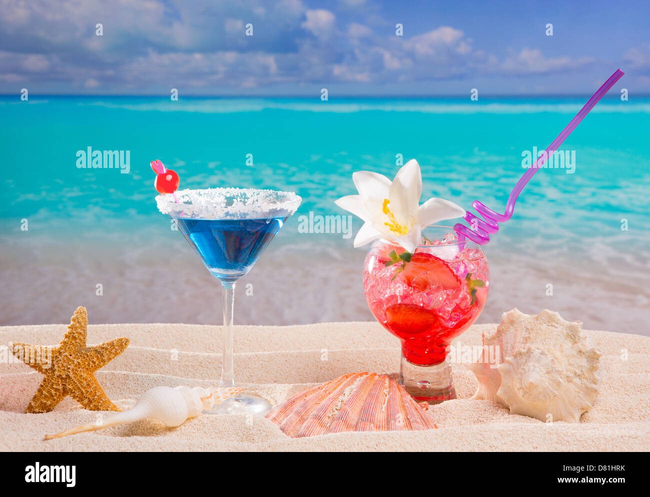 Beach tropical red and blue cocktail on caribbean white sand flower and ...