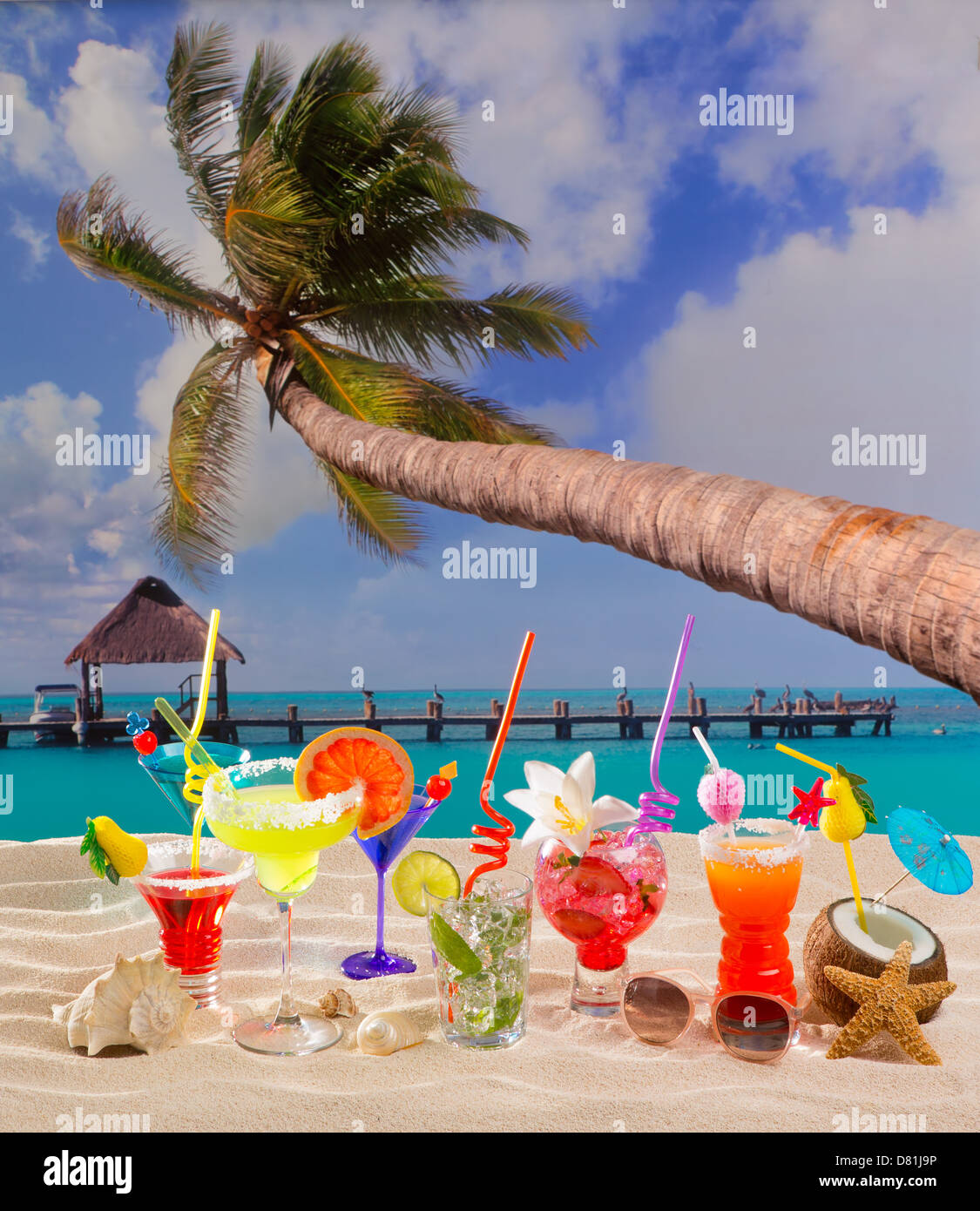 Colorful tropical cocktails at beach on white sand and palm tree Stock ...