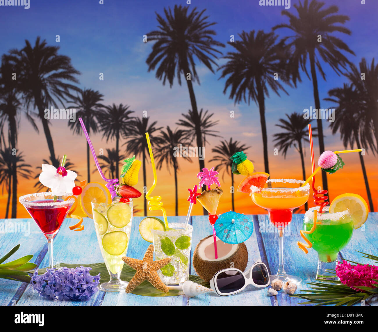 Colorful many tropical Cocktails in tropical blue wood Palm tree sunset ...