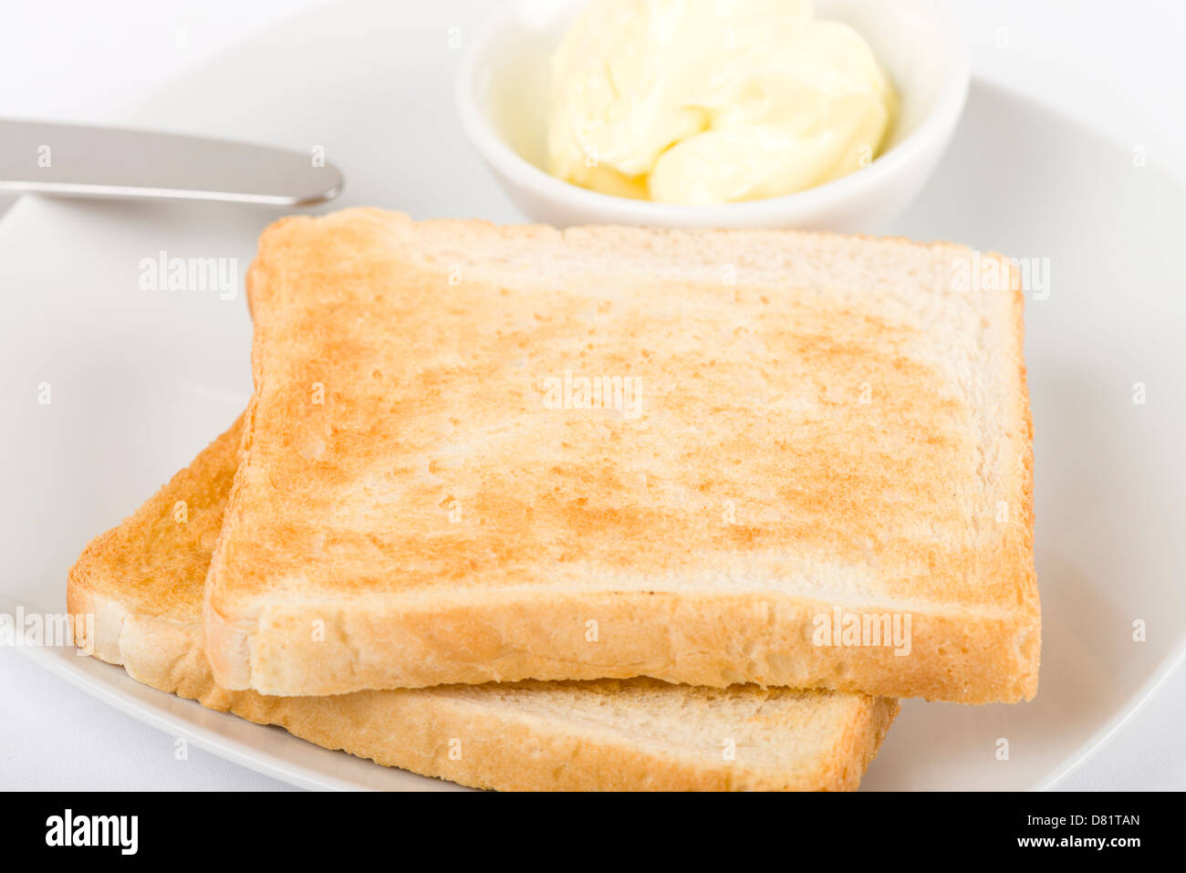 Simple Toast - Toasted sliced bread and butter on a white background ...