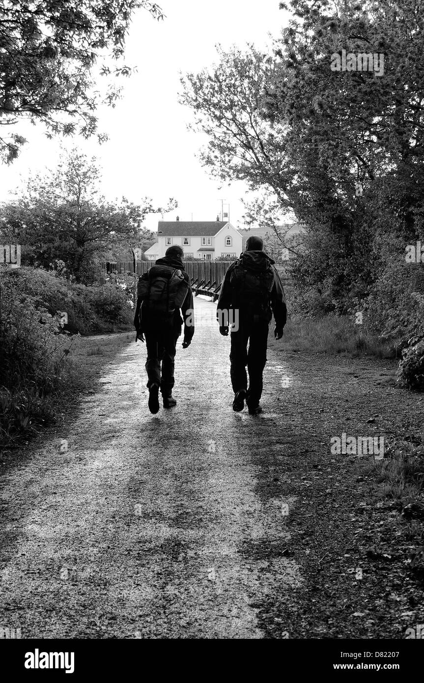 Two hikers in the rain on the Tarka Trai at Fremington Quay, North ...