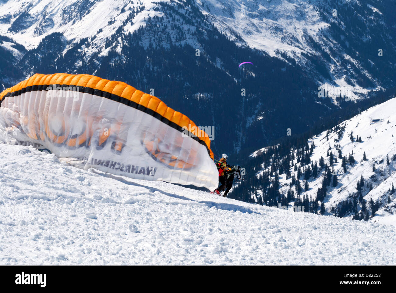 Paragliders (tandem) running to take off high above St Anton, in the ...