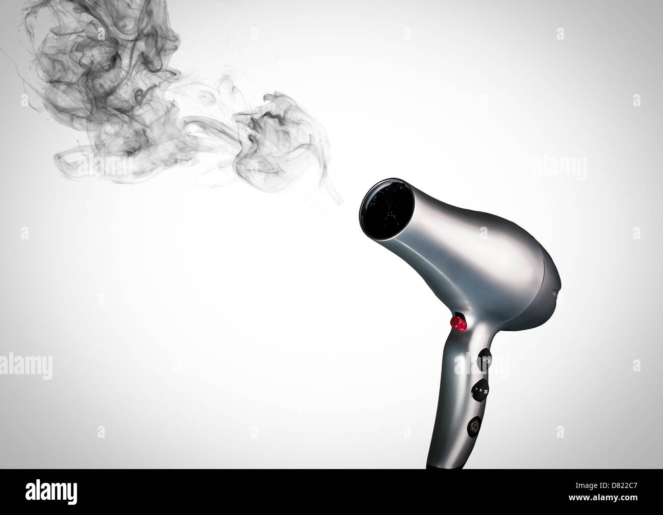 Creative image of a Hair Dryer blowing smoke Stock Photo - Alamy