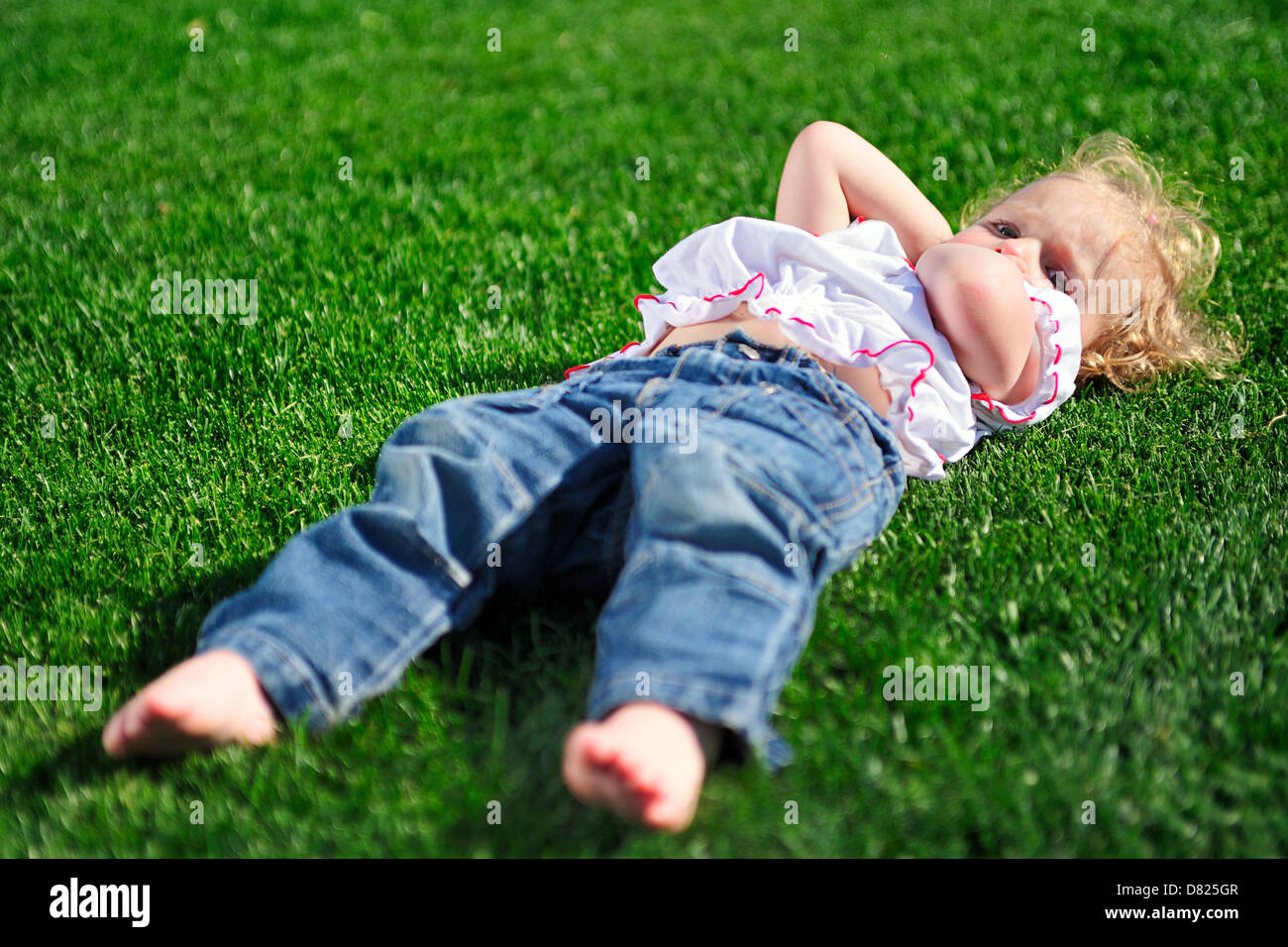 Little Girl Laying In Grass