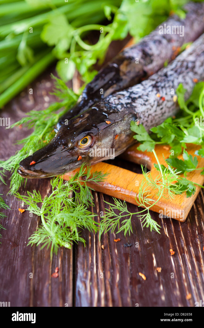 Uncooked fish on board, raw pike, food closeup Stock Photo - Alamy