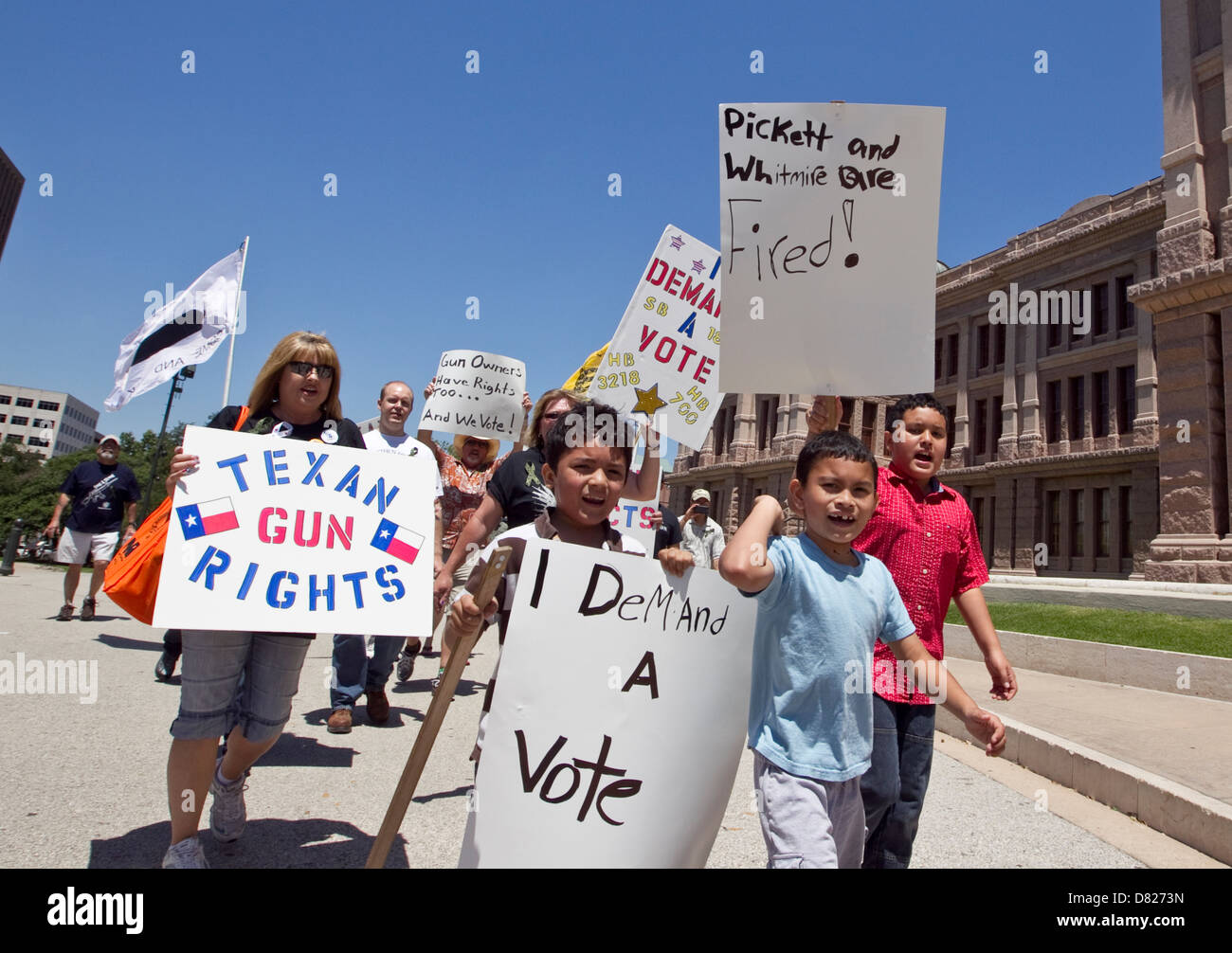 Gun rights advocates march around the Texas Capitol with signs asking ...