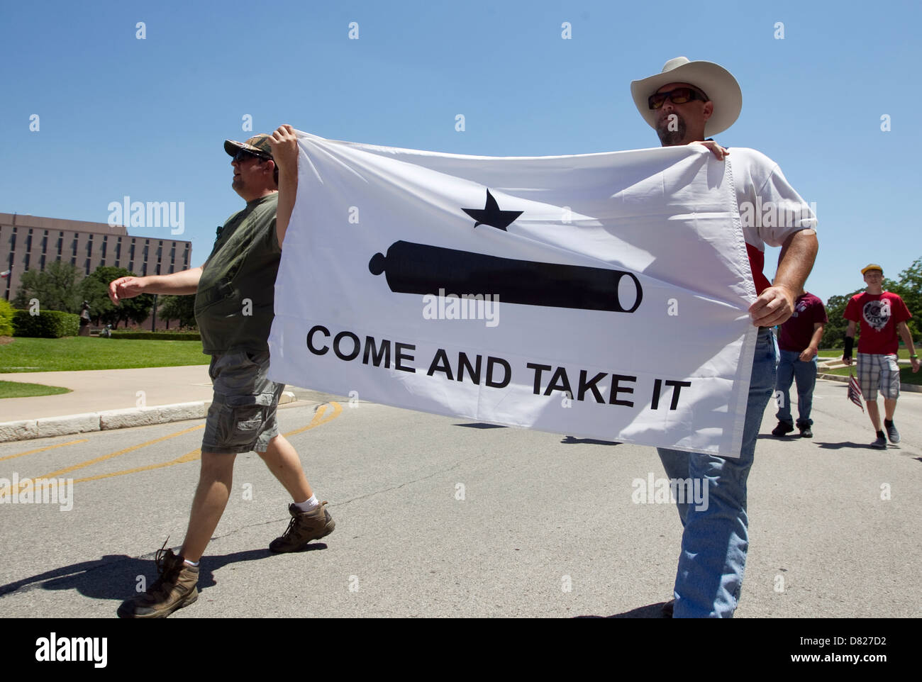White men carry a "Come and Take It" flag during a gun-rights protest ...