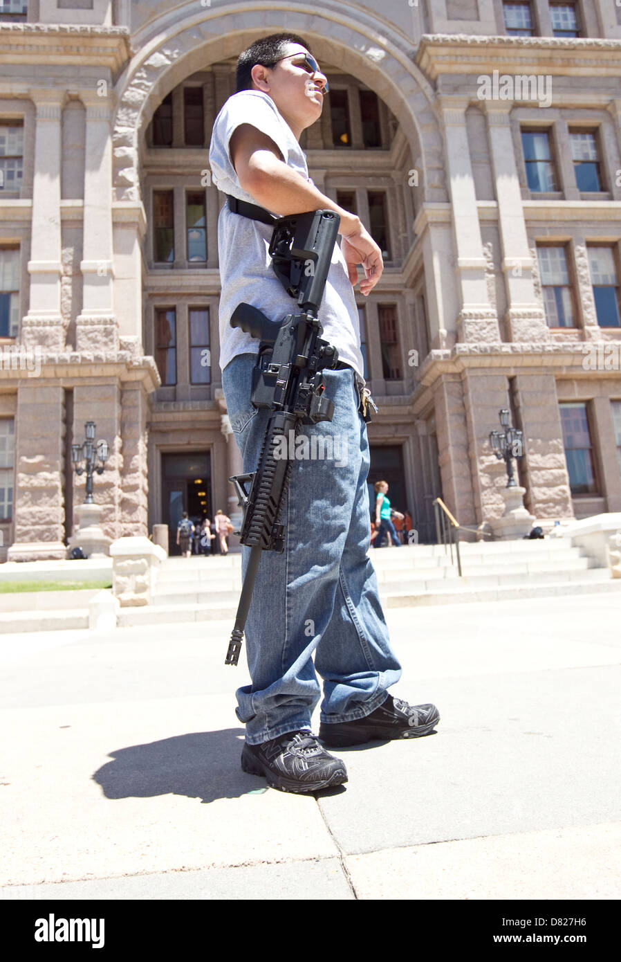 Man carries a semi-automatic rifle at a pro-gun rights rally at the ...