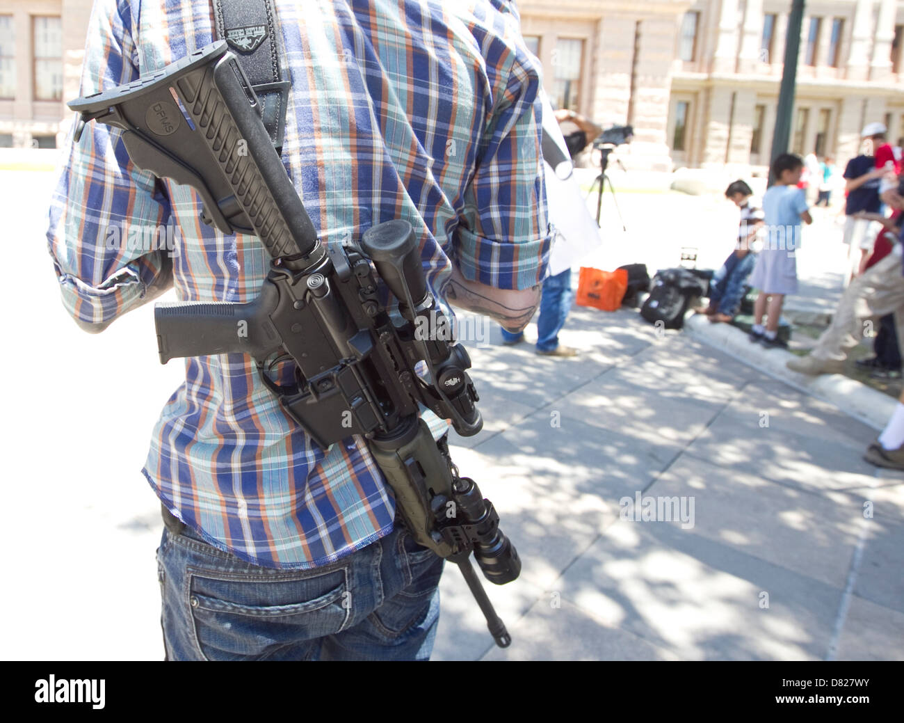 Man carries a semi-automatic rifle at a pro-gun rights rally at the ...