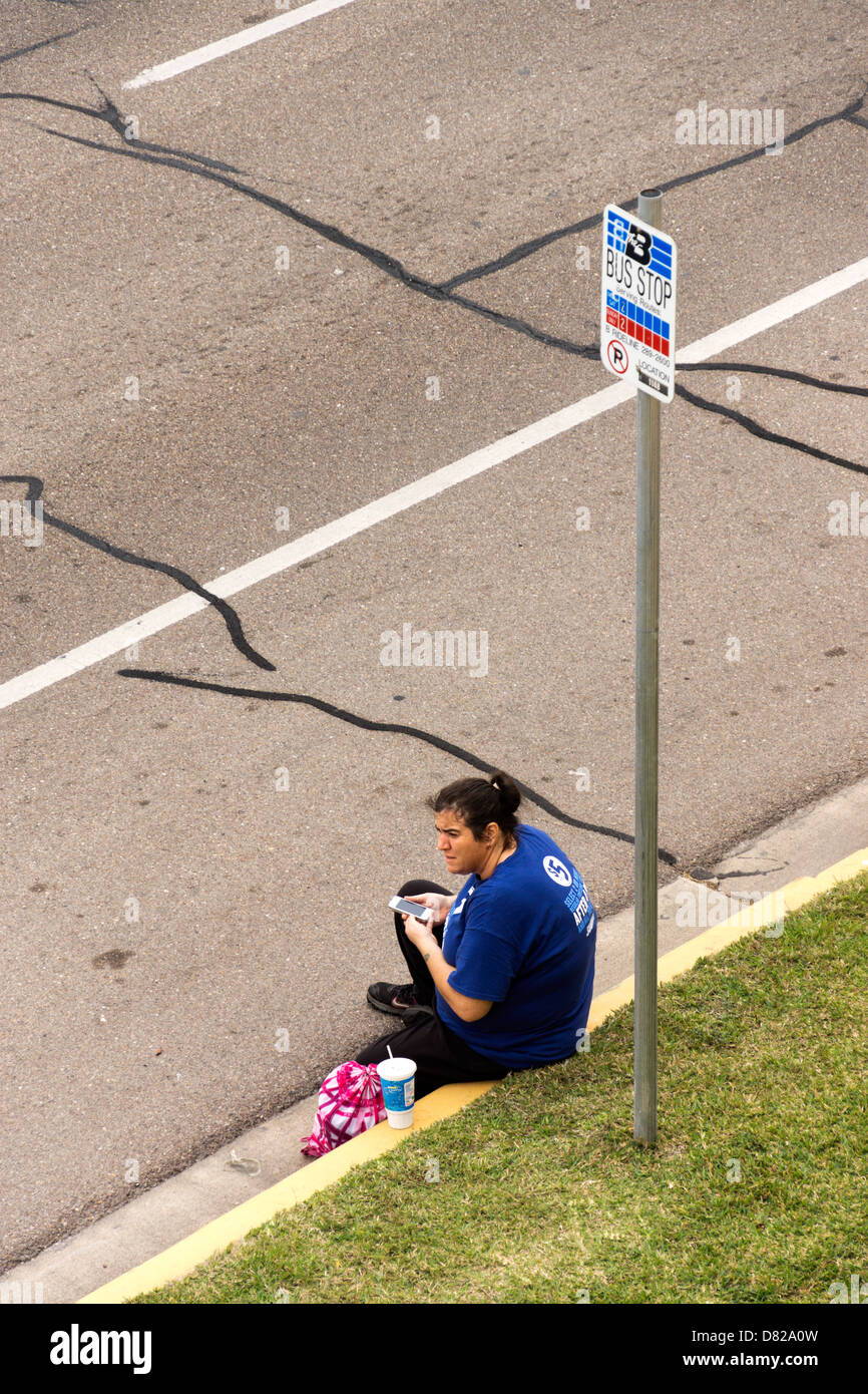 Woman sitting on curb waiting hi-res stock photography and images - Alamy