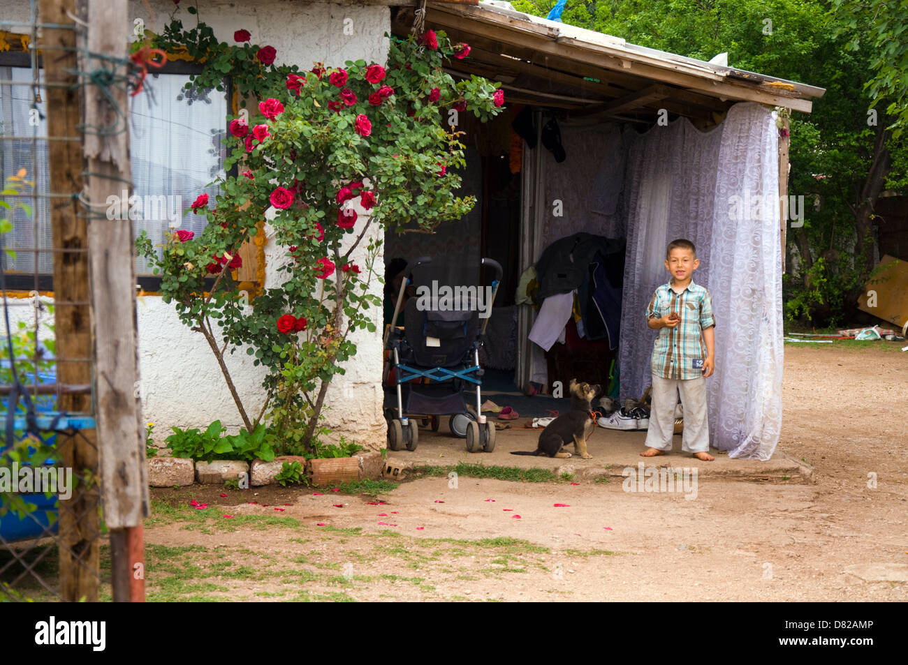 Roma child boy stands outside his home near Mostar in Bosnia ...