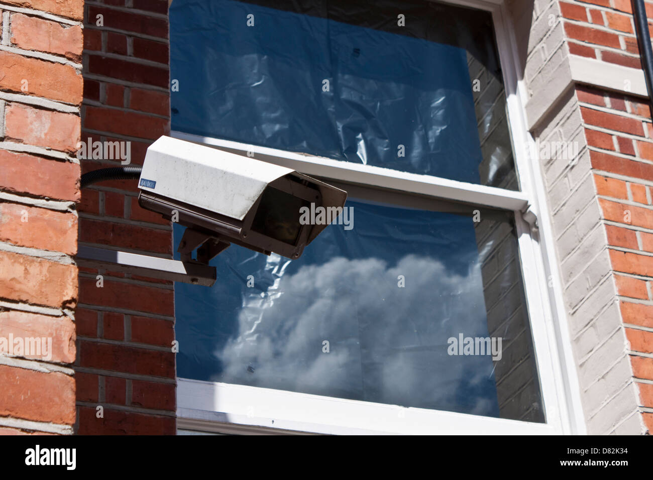 CCTV surveillance camera on building outside window Stock Photo - Alamy