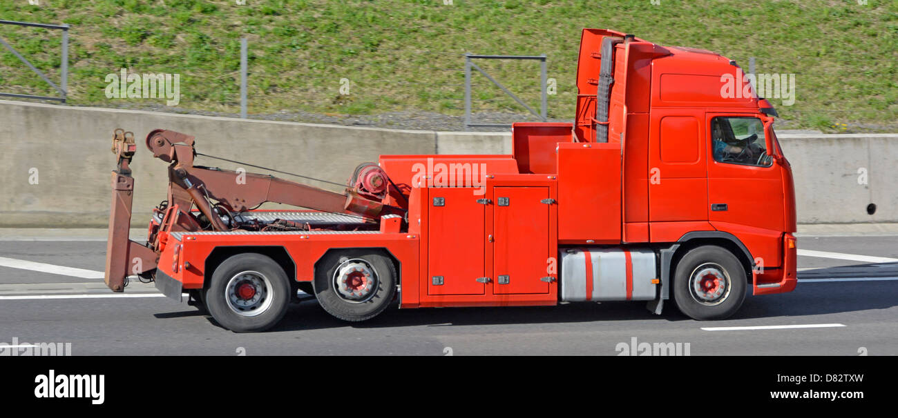 Unmarked side view clean red heavy lift breakdown recovery tow truck ...