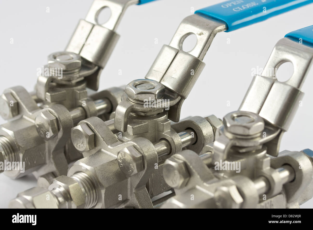 Stainless steel lever operated isolation valves on white background ...