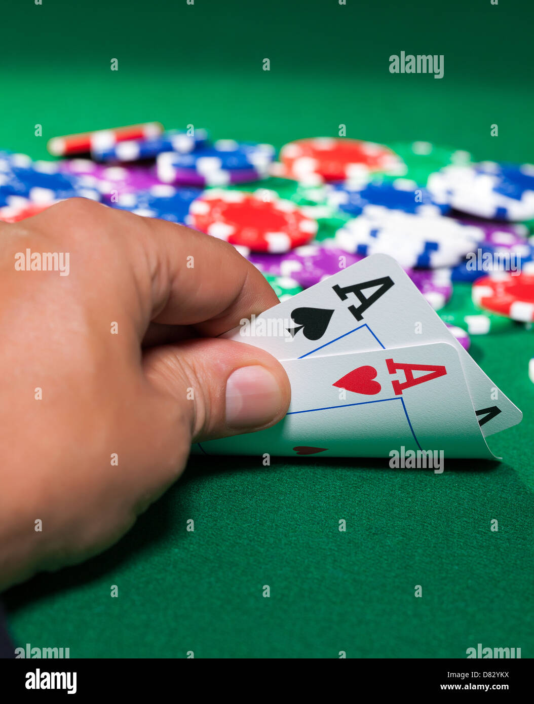 Colorful poker chips and two Ace closeup on green cloth Stock Photo - Alamy