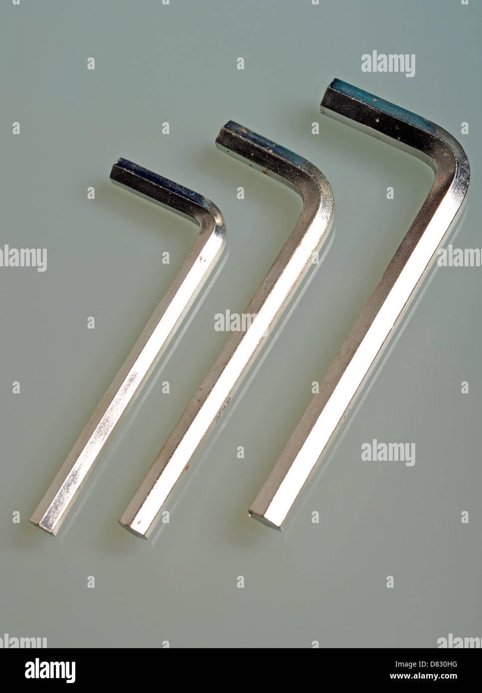 three allen wrenches on a plain background Stock Photo - Alamy