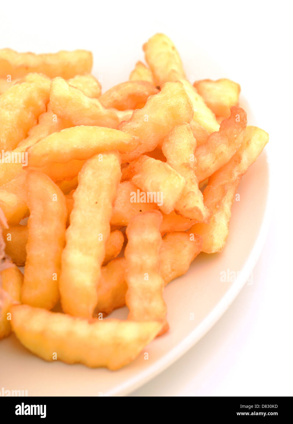 crinkle cut french fries on a plate with nobody Stock Photo - Alamy