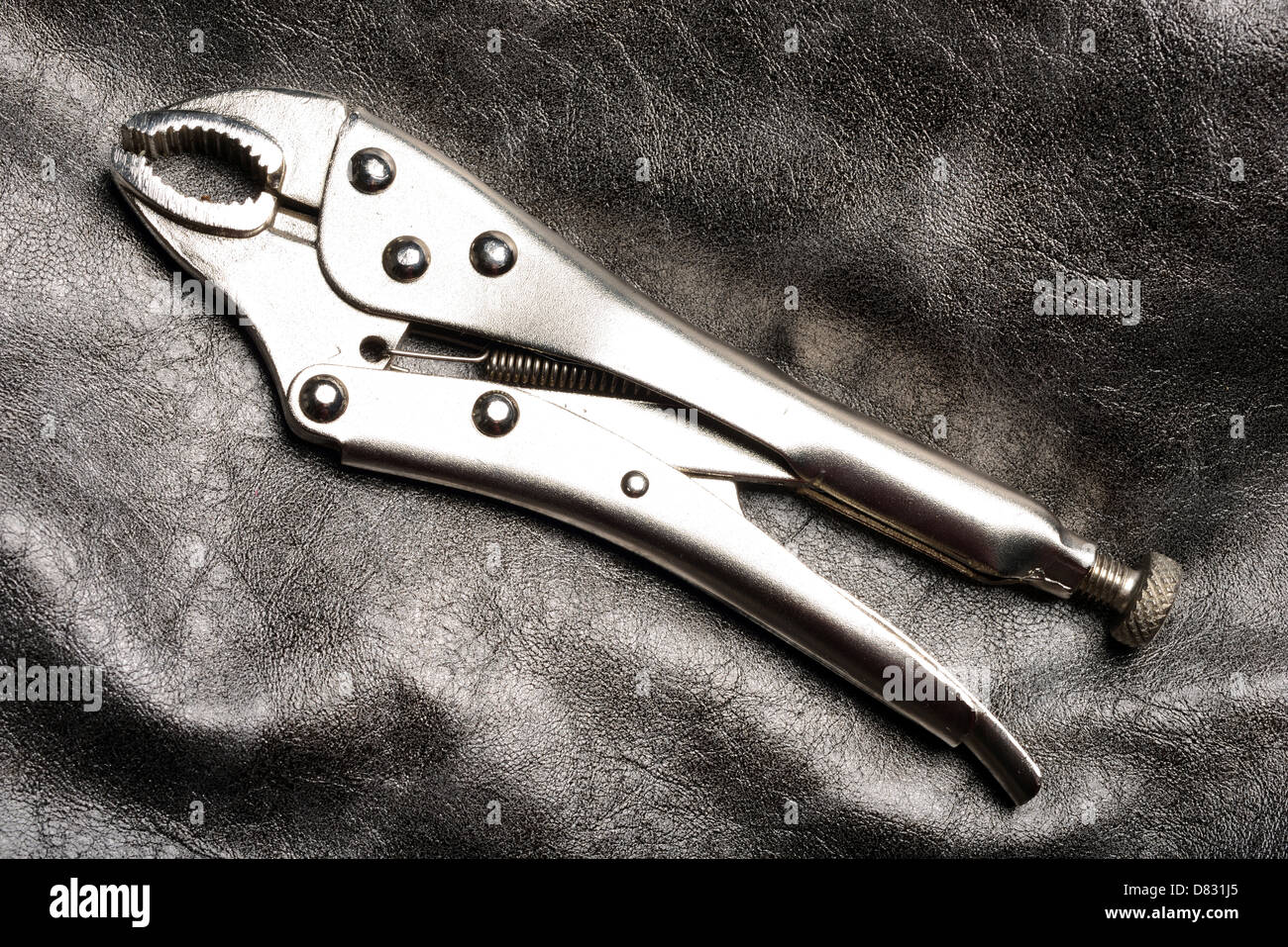 a vice grip on gray background with nobody Stock Photo - Alamy