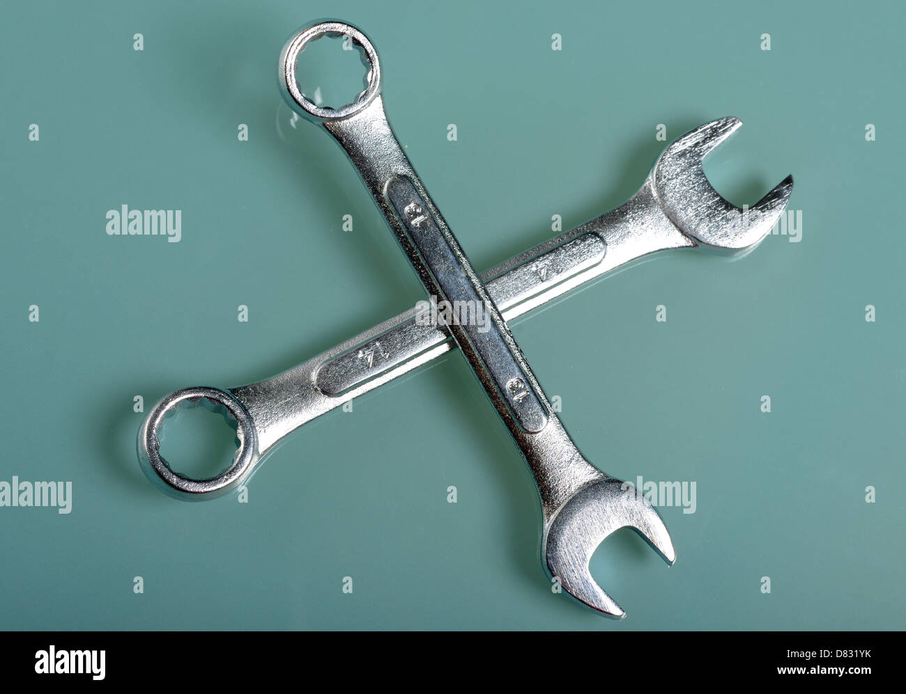 two wrenches crossing on a plain background Stock Photo - Alamy