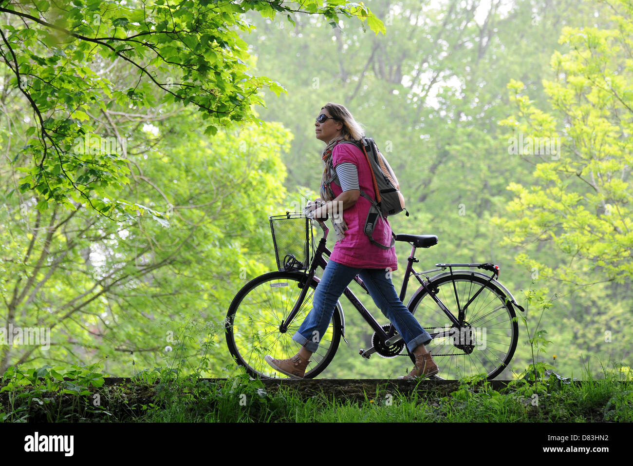 Girl pushing bike hi-res stock photography and images - Alamy