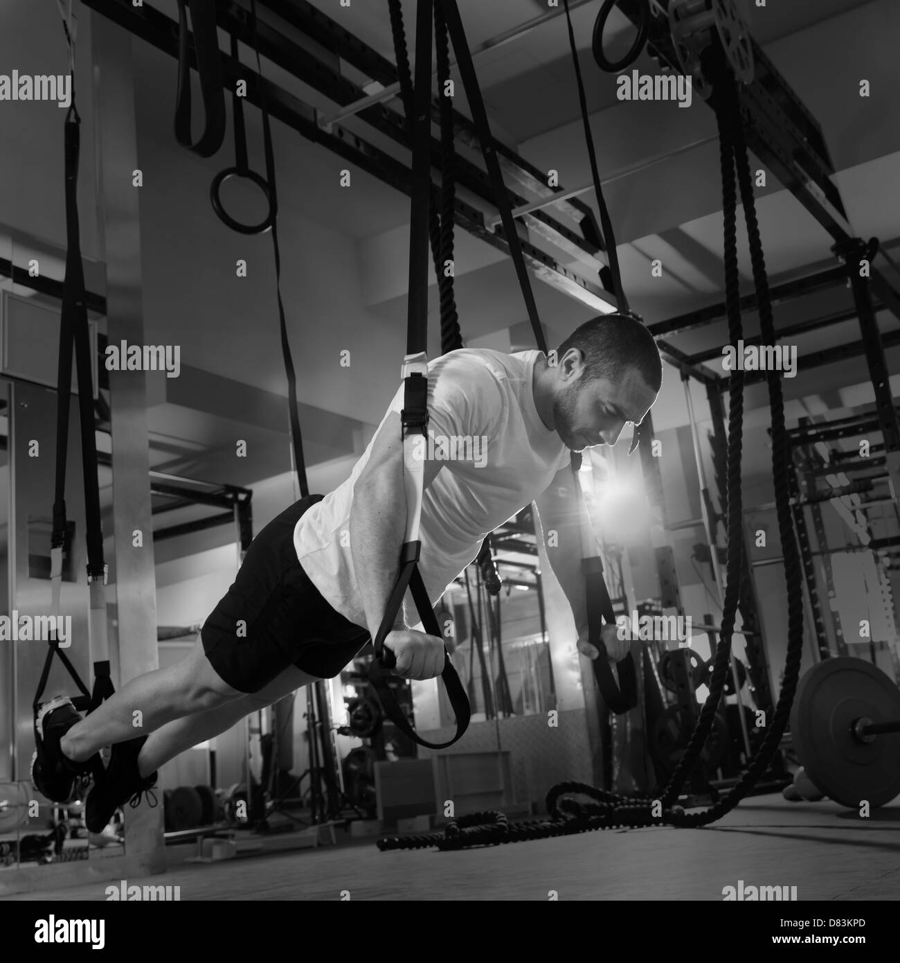 Crossfit fitness TRX push ups man workout at gym Stock Photo - Alamy
