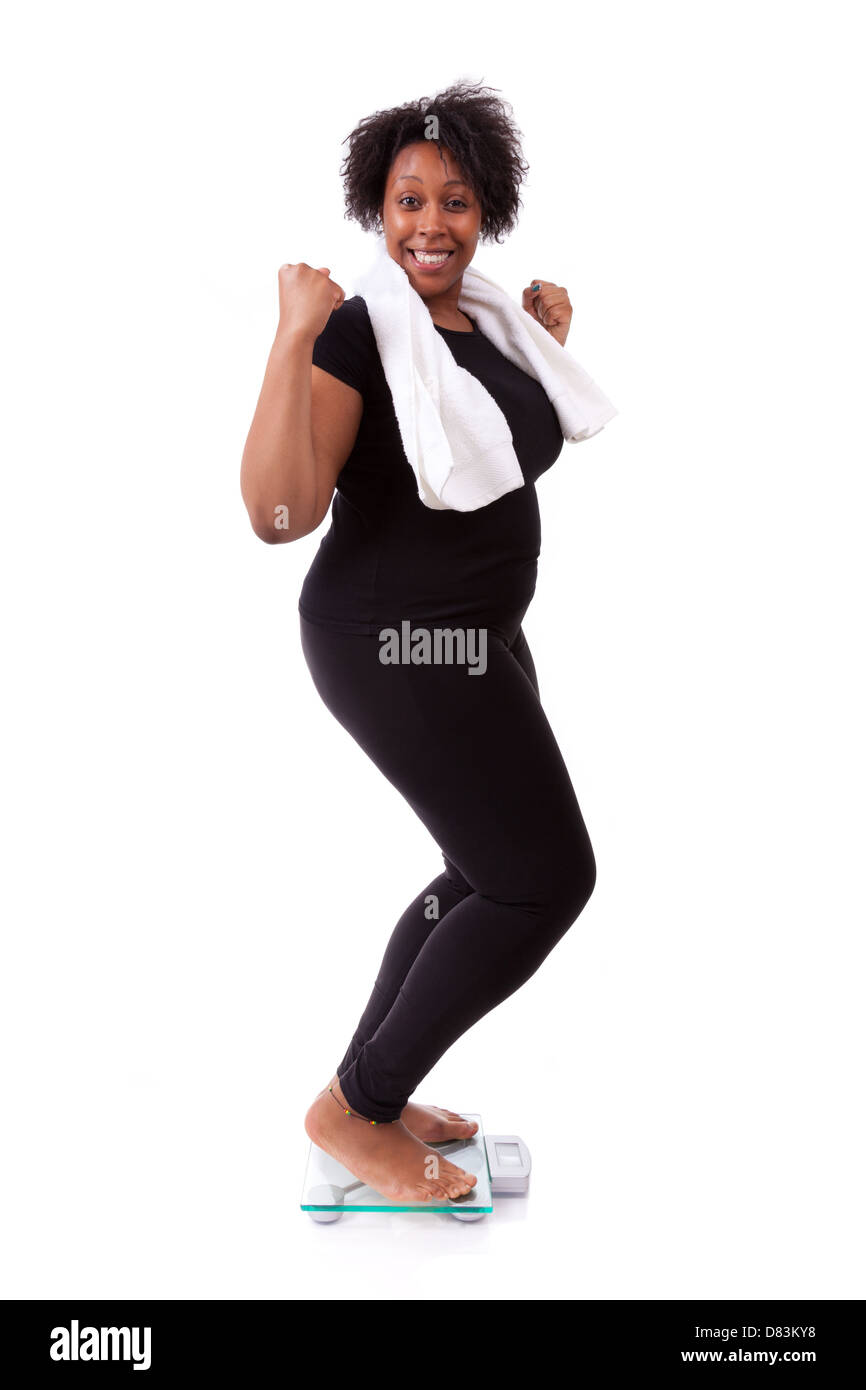 African American woman cheering on scale isolated over white background ...