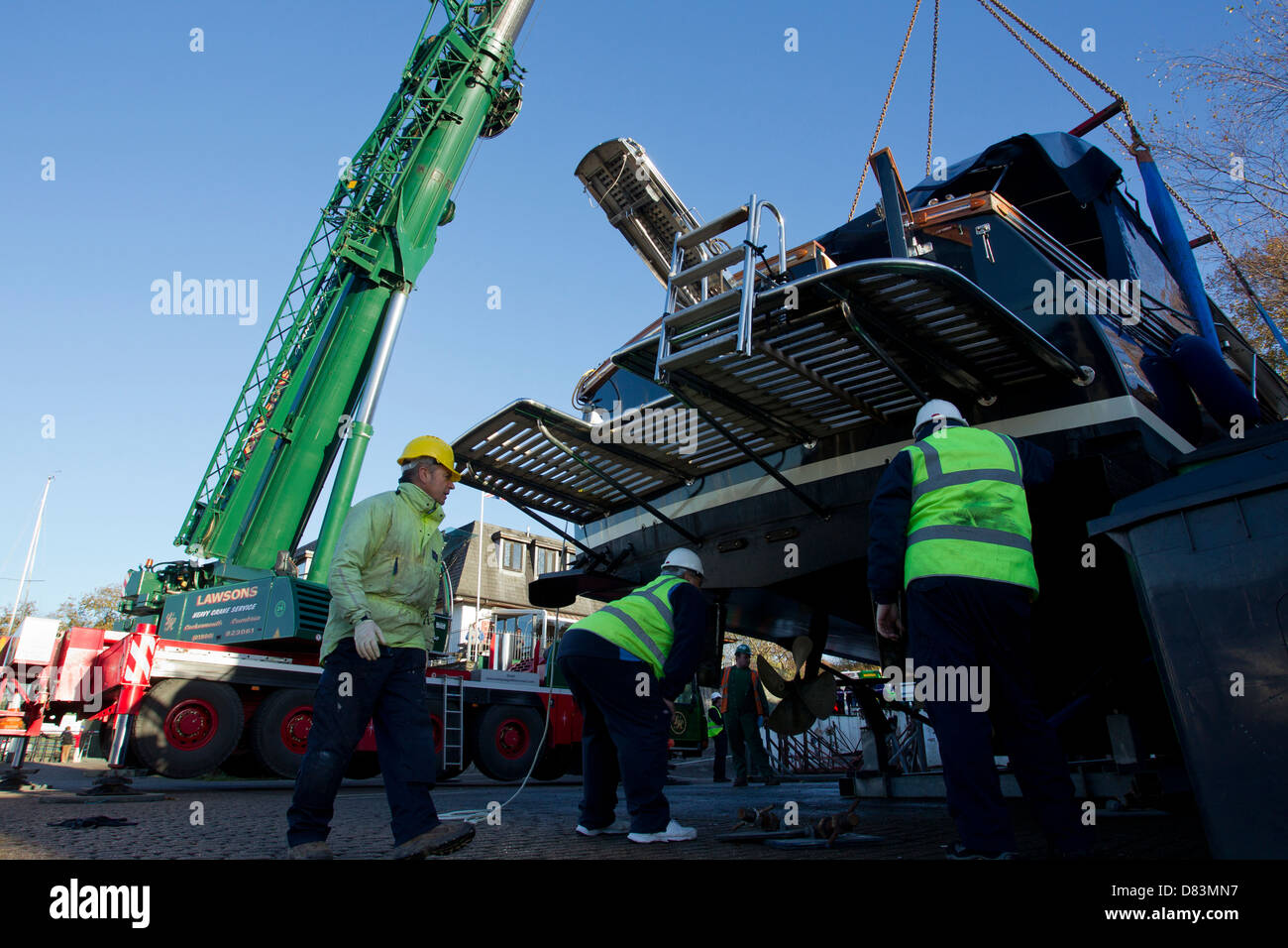 boat being taken out of the water by crane Stock Photo - Alamy
