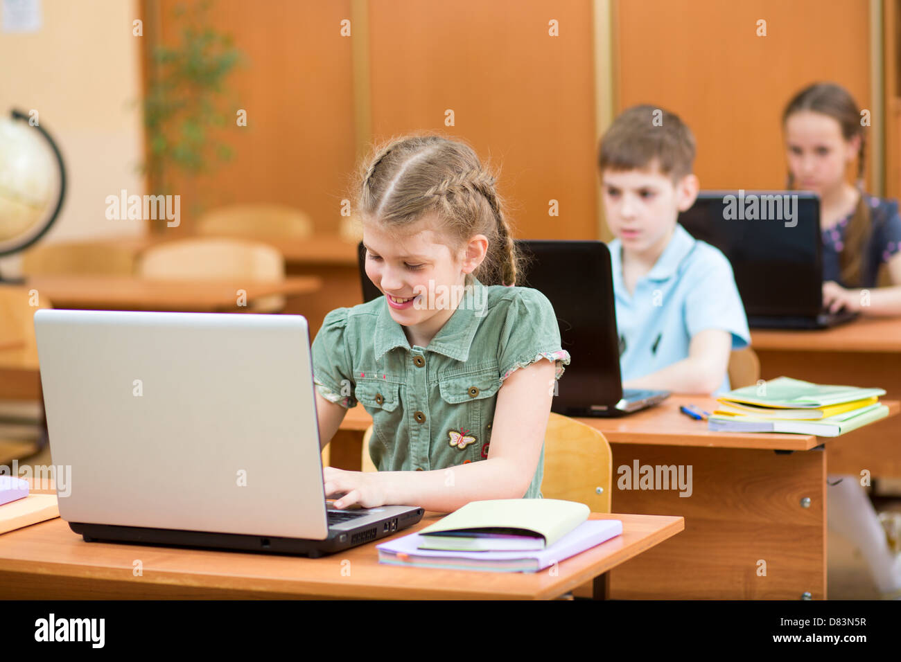 schoolkids using laptop at lesson Stock Photo - Alamy