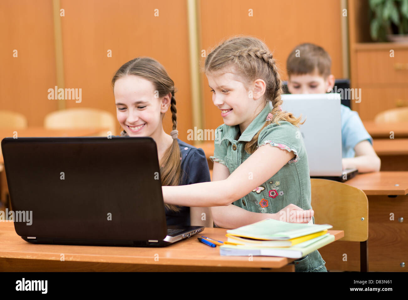 schoolkids using laptop at lesson Stock Photo - Alamy