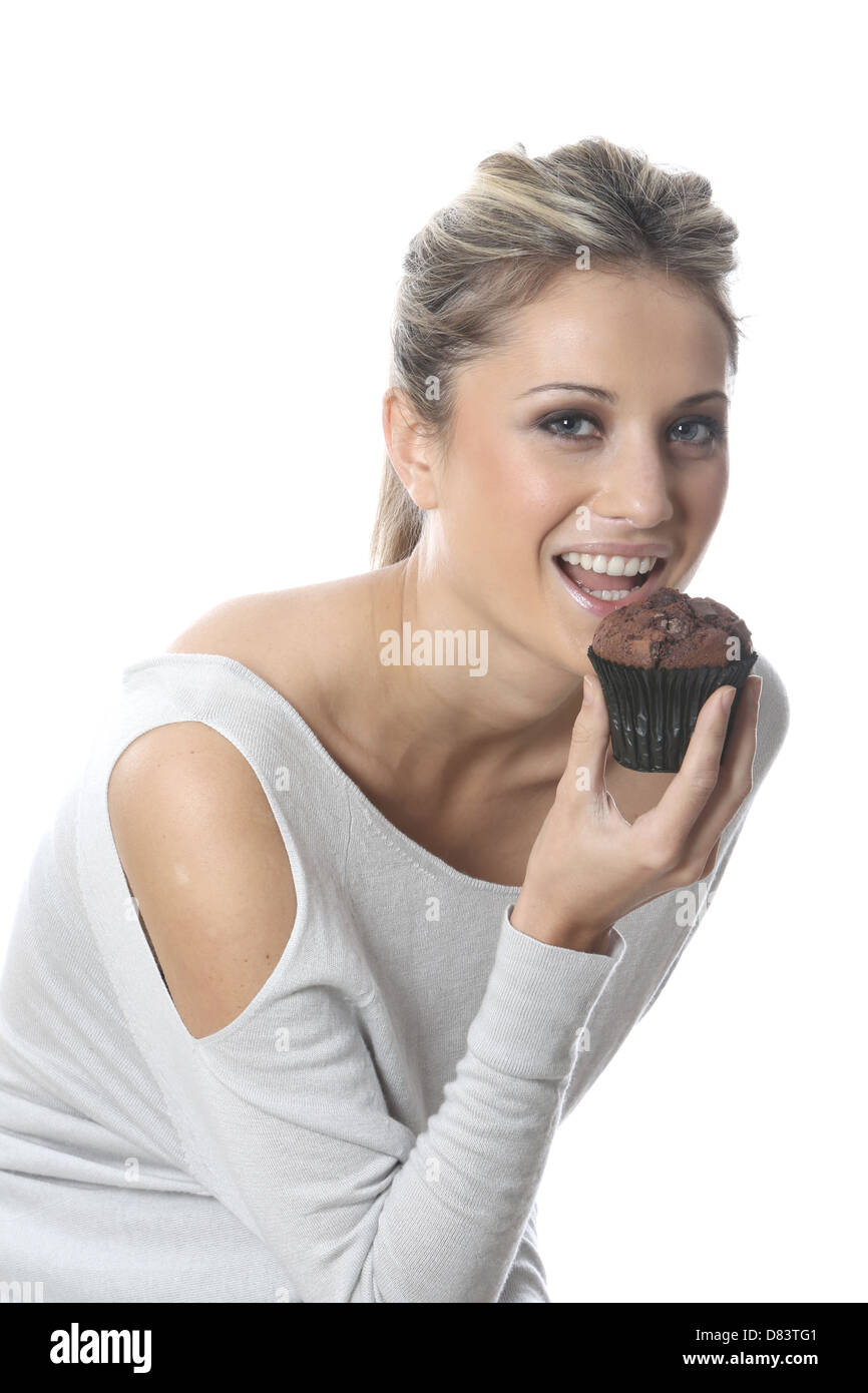 Model Released. Young Woman Eating Chocolate Muffin Stock Photo - Alamy