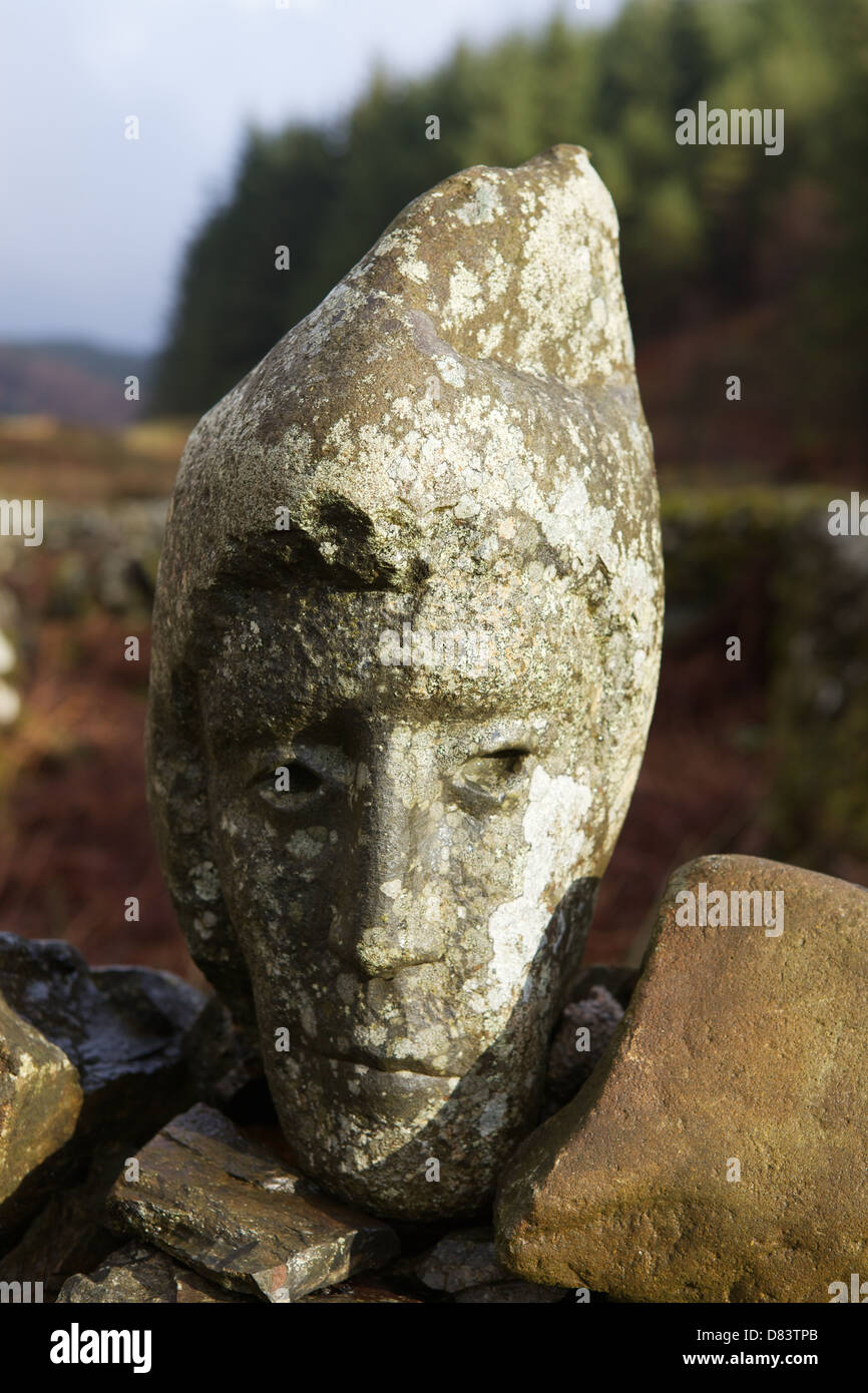 Stone sculpted human faces embedded in a dry stone dyke by Matt Baker ...