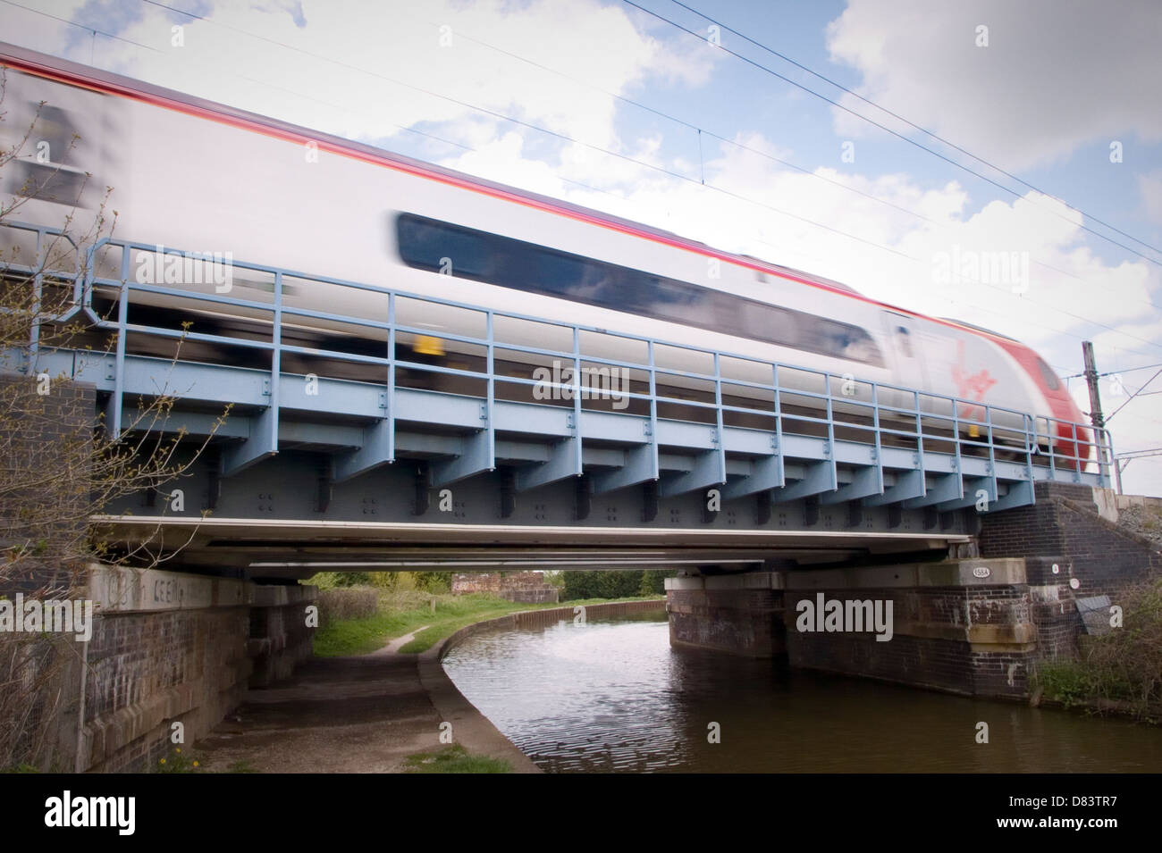 Virgin train over Trent and Mersey canal bridge near Sandbach Cheshire ...