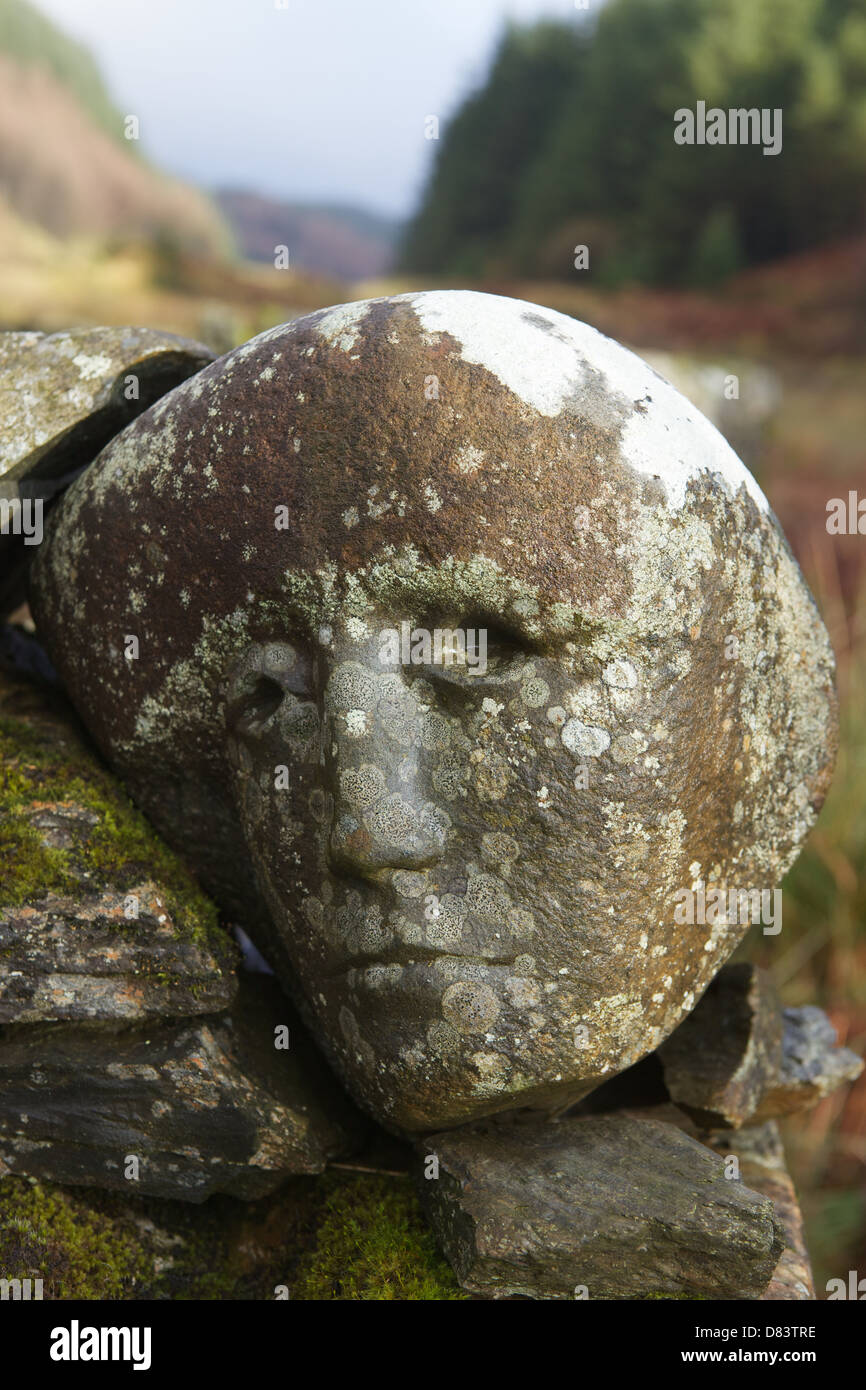 Stone sculpted human faces embedded in a dry stone dyke by Matt Baker ...