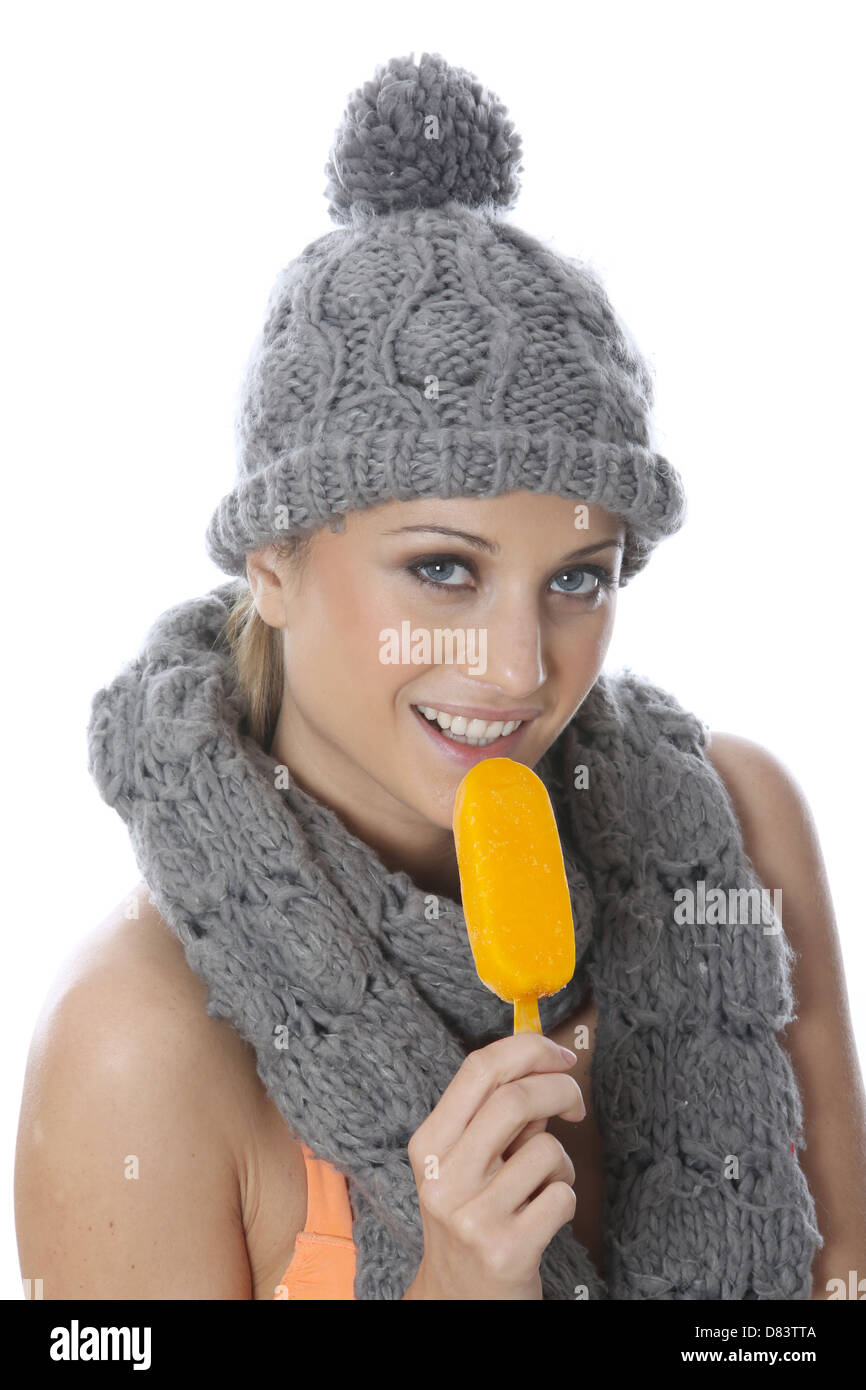 Model Released. Young Woman Wearing Woolen Hat and Scarf Eating Ice ...